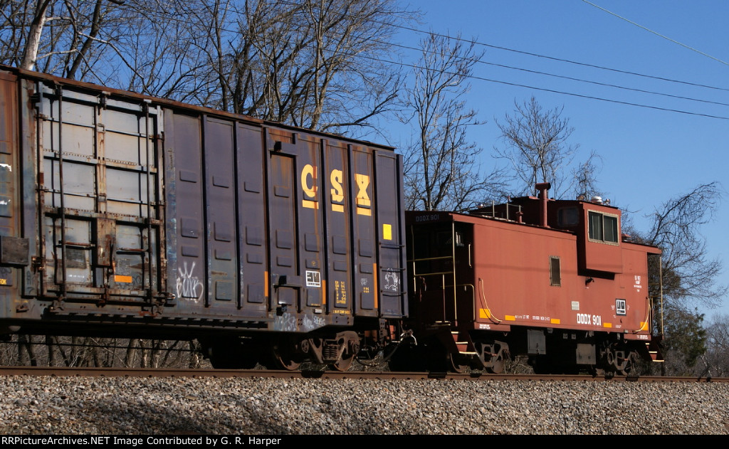 602 - DODX caboose 901 brings up the rear of Q303 at the west end of Reusens